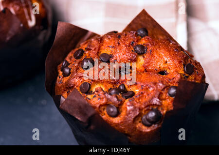 Close up. Dark key. Muffins with chocolate pieces in black paper Stock ...