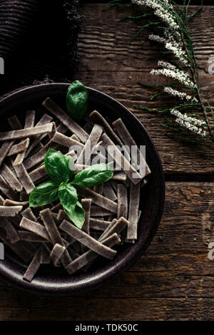 BUCKWHEAT PASTA WITH BASIL ON A WOODEN TABLE Stock Photo - Alamy