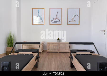 Pilates studio room with reformer beds Stock Photo - Alamy