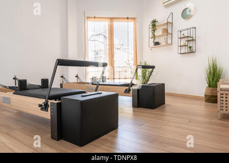 Pilates studio room with reformer beds Stock Photo - Alamy