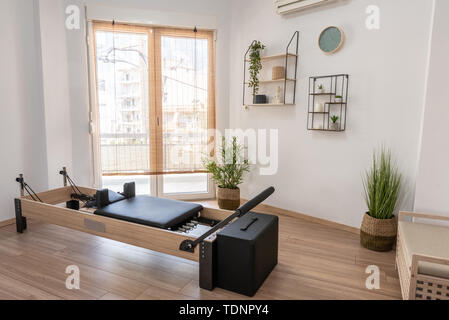 Pilates studio room with reformer beds Stock Photo - Alamy