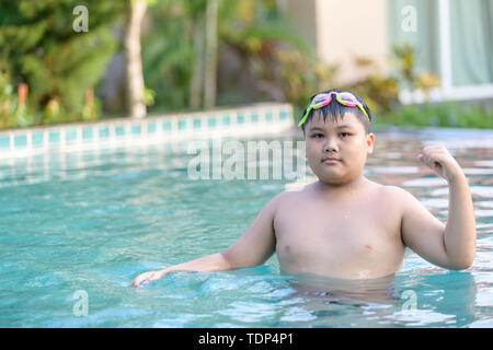 obese fat boy in swimming pool, concept healthy and exercise Stock ...