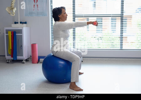 Female patient exercising with dumbbells in the hospital Stock Photo ...