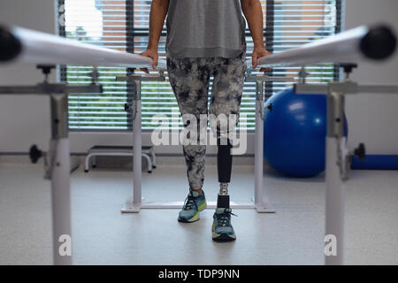 Female patient walking with parallel bars in hospital Stock Photo - Alamy
