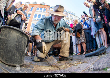 German artist Gunter Demnig puts stumbling stones at the center city of ...