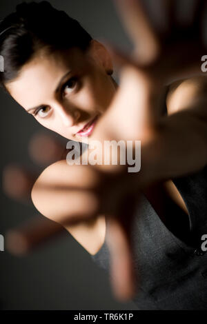 selective focus of brunette woman with outstretched hand lying on bed ...