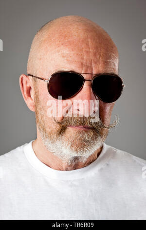 old man with bald head and grey beard is concerned and putting his head ...
