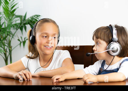 Hispanic school boy wearing headphones, preparing homework while ...