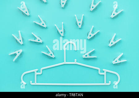Top view of white clothes hangers on blue background with copy space ...