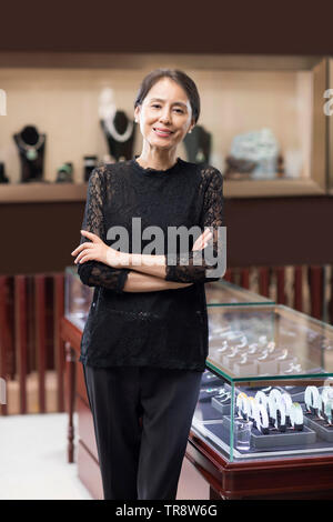 Elegant shopkeeper in jewelry store Stock Photo - Alamy