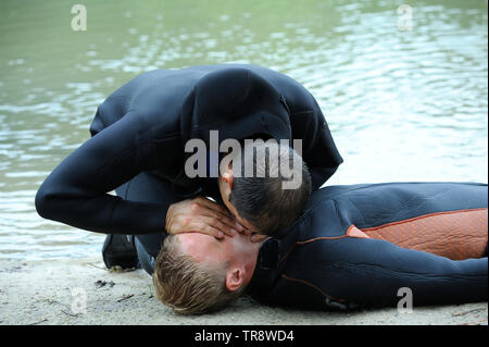 Lesson of artificial respiration. Lifeguard giving drowning mouth-to-mouth resuscitation Stock ...