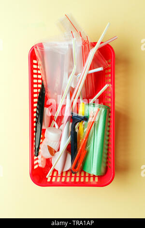 Single-use plastic objects, ecological pollution. Plastic waste. Orange ...