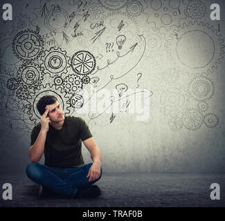 Serious young man thinking very hard solving a problem Stock Photo - Alamy
