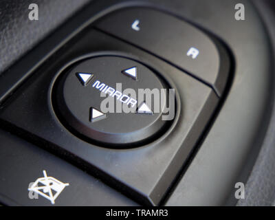 Side mirrors control panel on side door. Car driver adjust side mirror ...