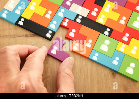 image of tangram puzzle blocks with people icons over wooden table ...