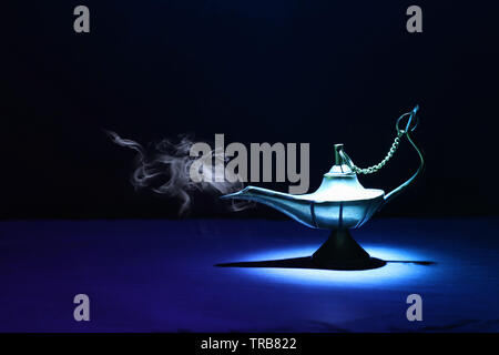 Image of magical mysterious aladdin lamp with smoke. Dark background ...