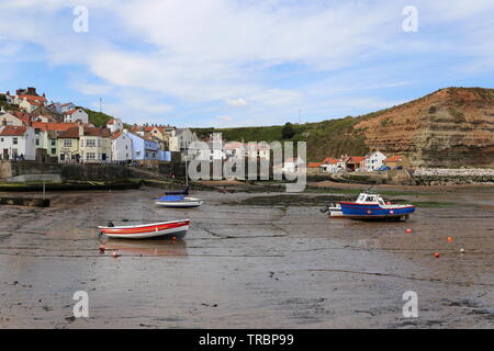 Staithes harbour with a grounded fishing boat at low tide a village in ...