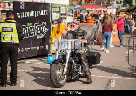 Killarney Ireland Bike Fest gathering. Senior rider biker in brown ...