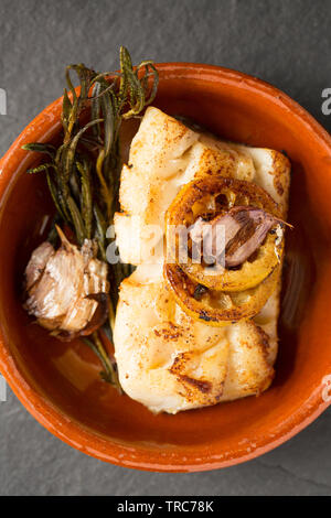 A cooked, thick fillet of pollack, Pollachius pollachius, that was ...