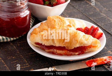 Croissants Filled with Fresh Homemade Strawberry Jam on a Wooden Table ...