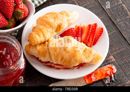 Croissants Filled with Fresh Homemade Strawberry Jam on a Wooden Table ...