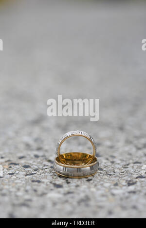Golden wedding rings on a stone surface Stock Photo - Alamy