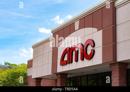 A logo sign outside of a AMC Theatres movie theater in Columbia ...