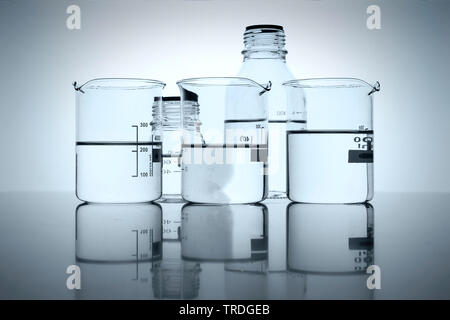 Laboratory flasks and beakers with liquids of different colors on lab ...