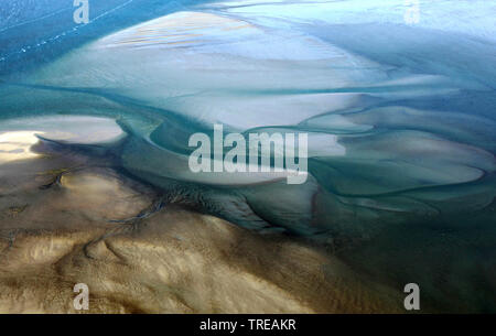 Tidal flat and sandbanks during low tide with sky reflected in shallow ...