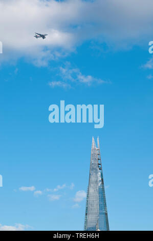 Plane flying very close to the Shard Building in London Stock Photo ...