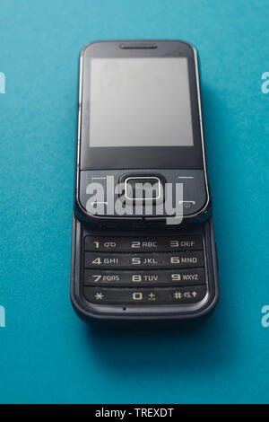 Retro mobile phone with a classic button design on a transparent ...