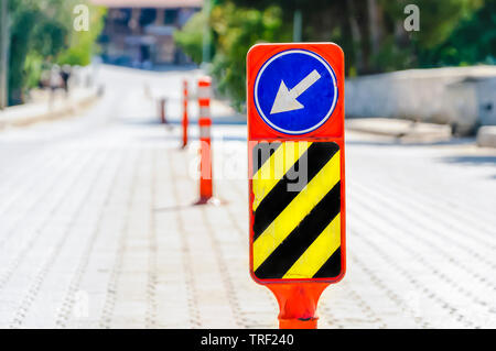 Keep left bollard on traffic island in middle of road Stock Photo - Alamy