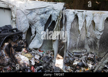 Strange forms of melted pvc garbage cans after a fire Stock Photo - Alamy
