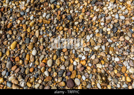 small to medium sized rocks on a beach during a sunny day Stock Photo ...
