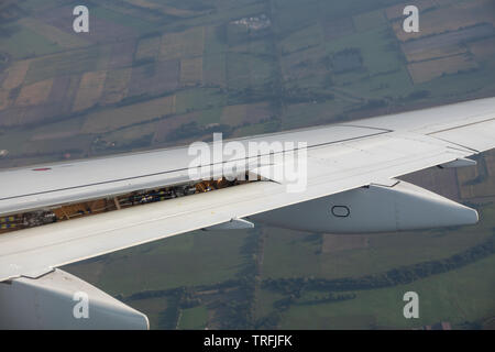 aircraft wing spoiler deployed during landing showing hydraulics Stock ...