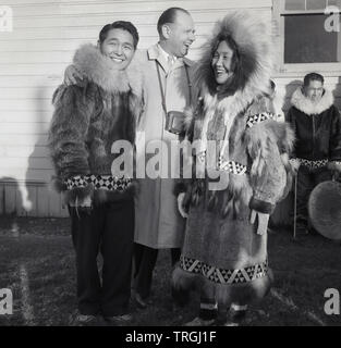 1950s, historical, Native Alaskian people line up wearing some of the ...