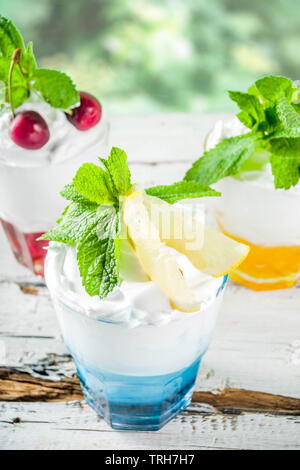 Summer cold drinks. Colorful Italian cream soda cocktails over white ...