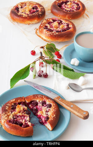 Table with yeasty sweet pastry with fresh cherries and streusel topping ...