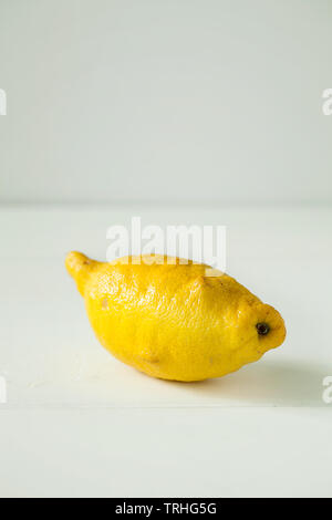 Trendy ugly organic lemon unusual shape on white background with copy ...