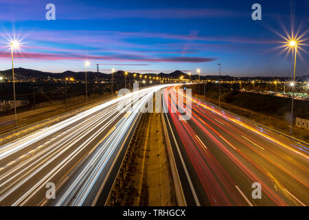 Freeway at dusk, two-way traffic with light trails Stock Photo - Alamy