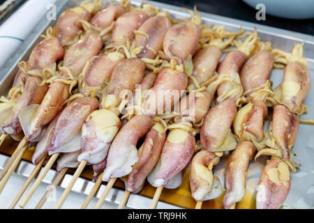 Fresh squid yellow stab arranged on tray Stock Photo - Alamy