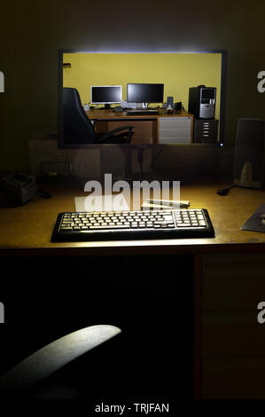 Computer screen illuminated at night in home office Stock Photo - Alamy
