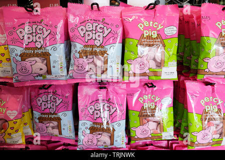 A packet of M&S Percy Pig sweets shot on a yellow background Stock Photo - Alamy