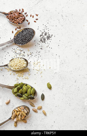 Wooden spoons with flaxseed on a stone background. Top view Stock Photo ...