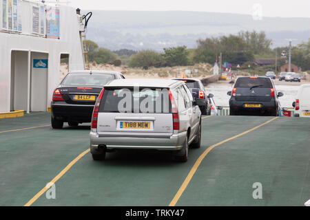 Cars driving on and off the Sandbanks chain ferry, Poole Harbour ...