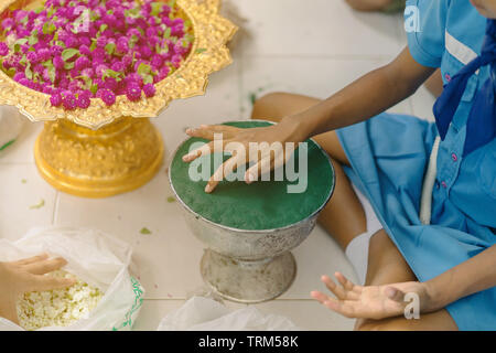 Students help each other to create a flowers tray with pedestal for The ...