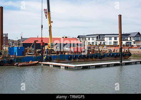 Piling barge drilling in pontoon pile in Arboath harbour, Angus ...