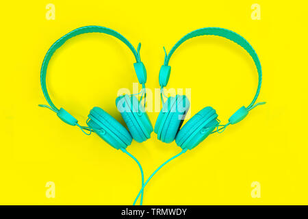 Turquoise or blue headphones or a computer headset on a yellow ...