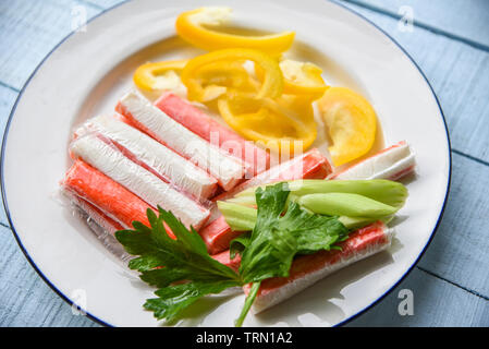 Crab sticks with sweet bell peppers and fresh Celery vegetable on plate ...