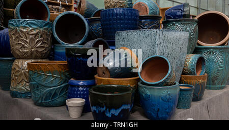 Large glazed and terracotta earthenware pots stacked in the sun Morris ...